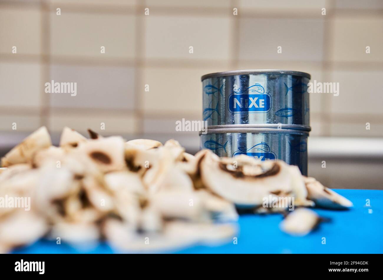 POZNAN, POLAND - Nov 30, 2017: Nixe tuna in a can behind cut mushrooms ...