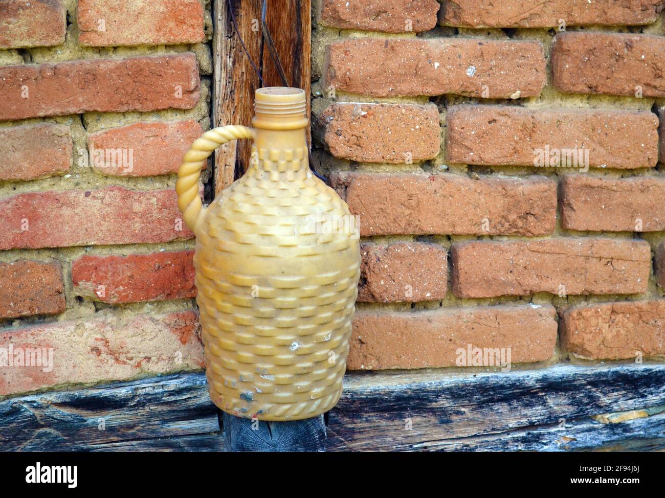Vintage Plastic water container for multiple use in front of brick wall ...