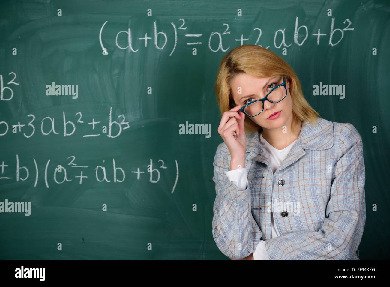teacher on school lesson at blackboard. woman in classroom. School ...