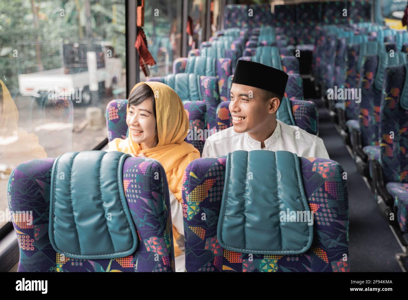muslim couple travel by bus during eid mubarak holiday Stock Photo - Alamy