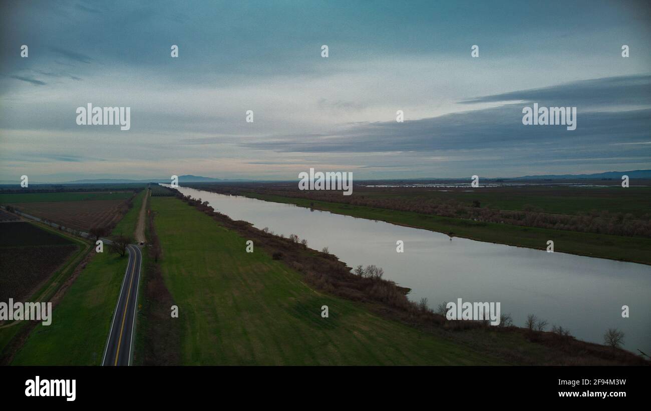 Shot of green lands and river leading to the horizon Stock Photo - Alamy