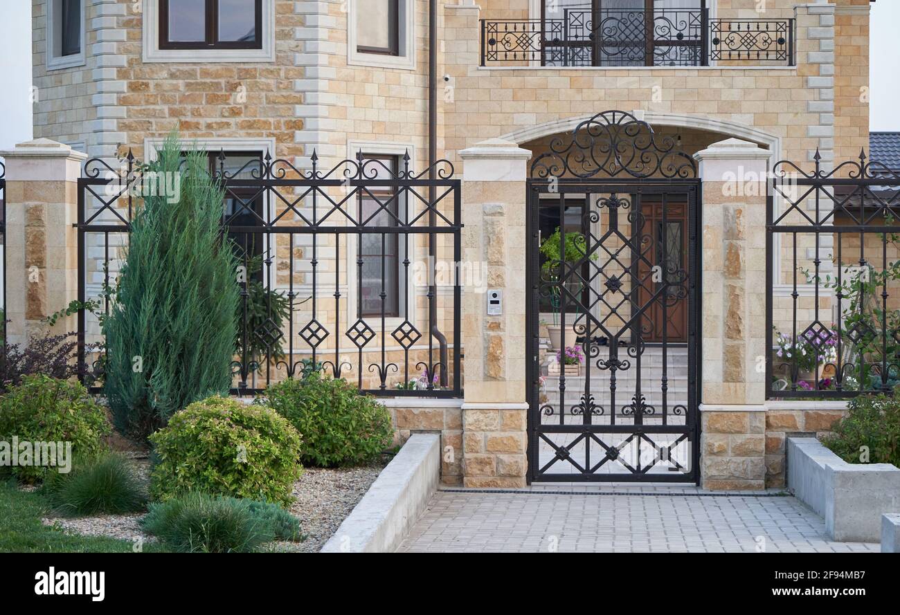 luxury metal forged front door and fence in a private house Stock Photo ...