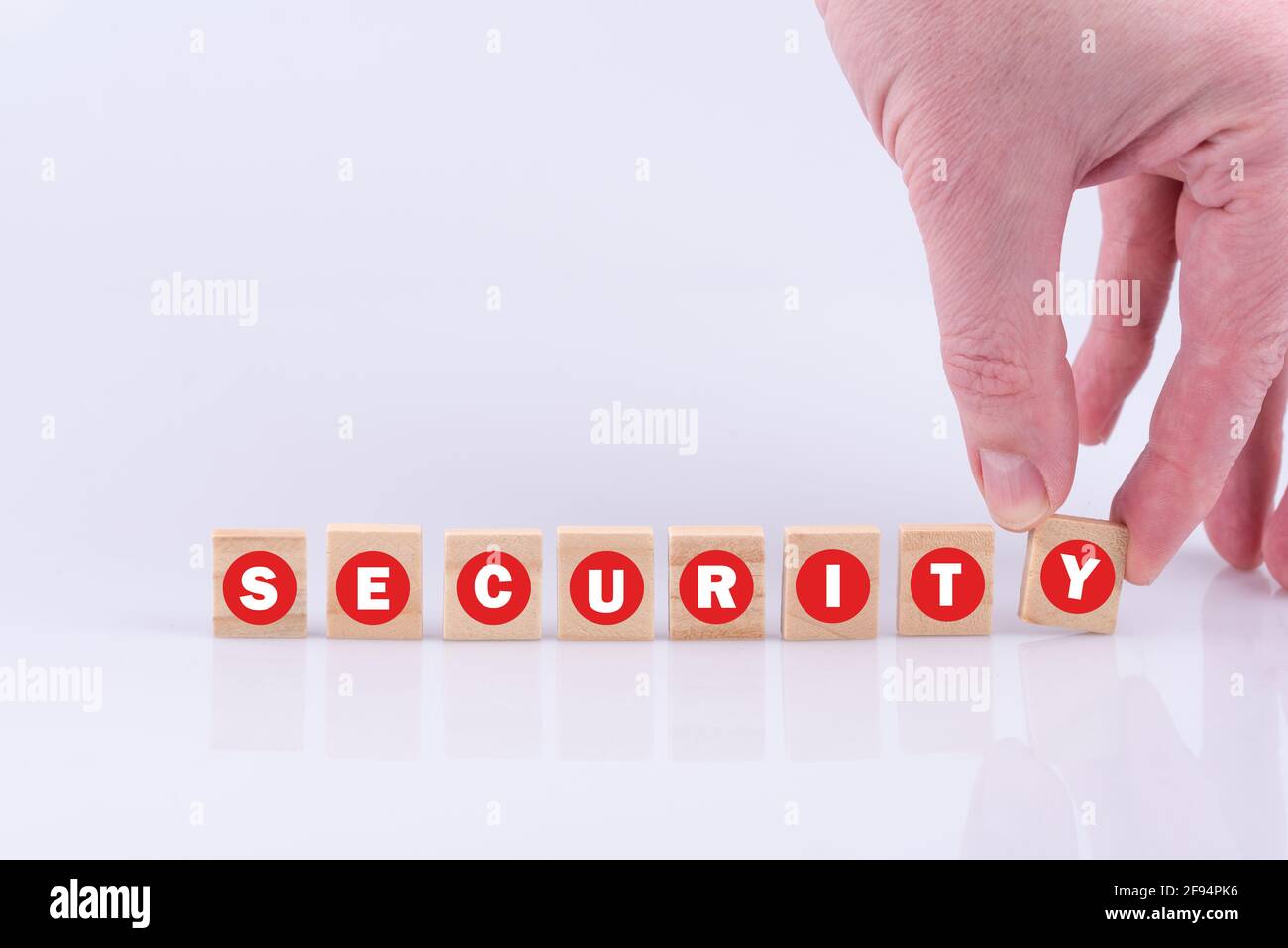Word Security spelled from single dice letters, hand putting on the ...