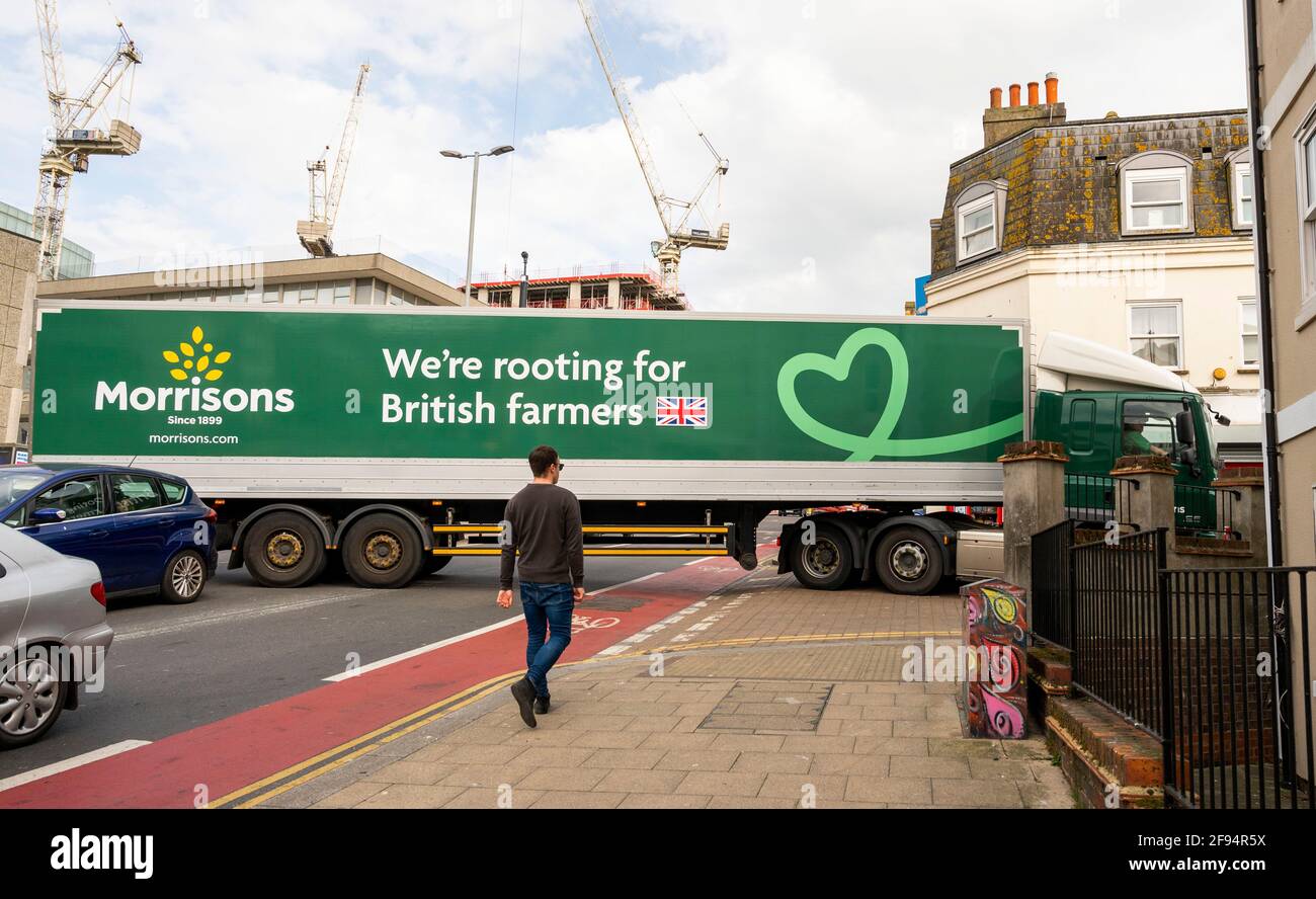 Large Morrisons supermarket articulated delivery lorry turning a tight ...
