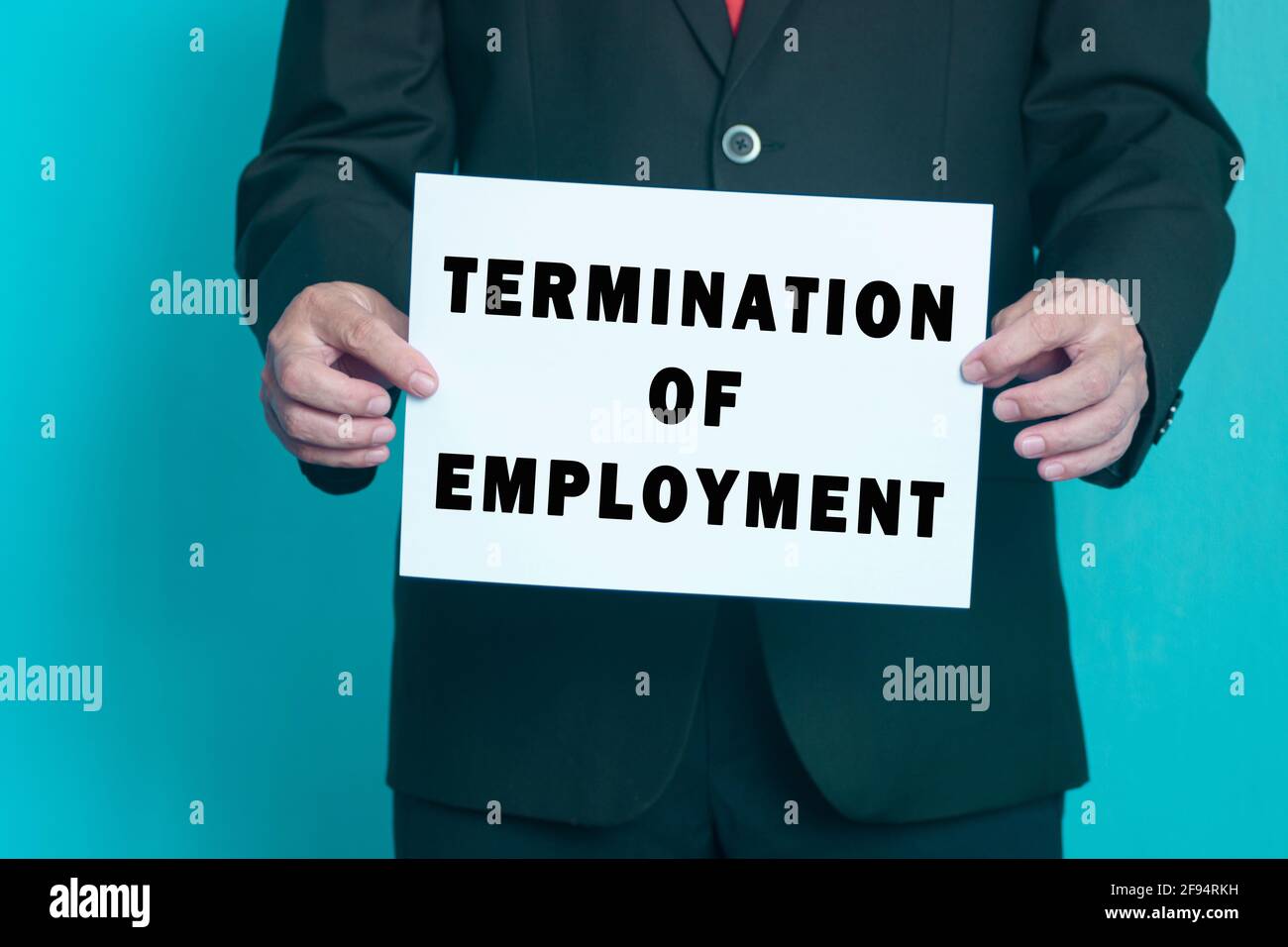 A business man holding a paper with text on a green background ...