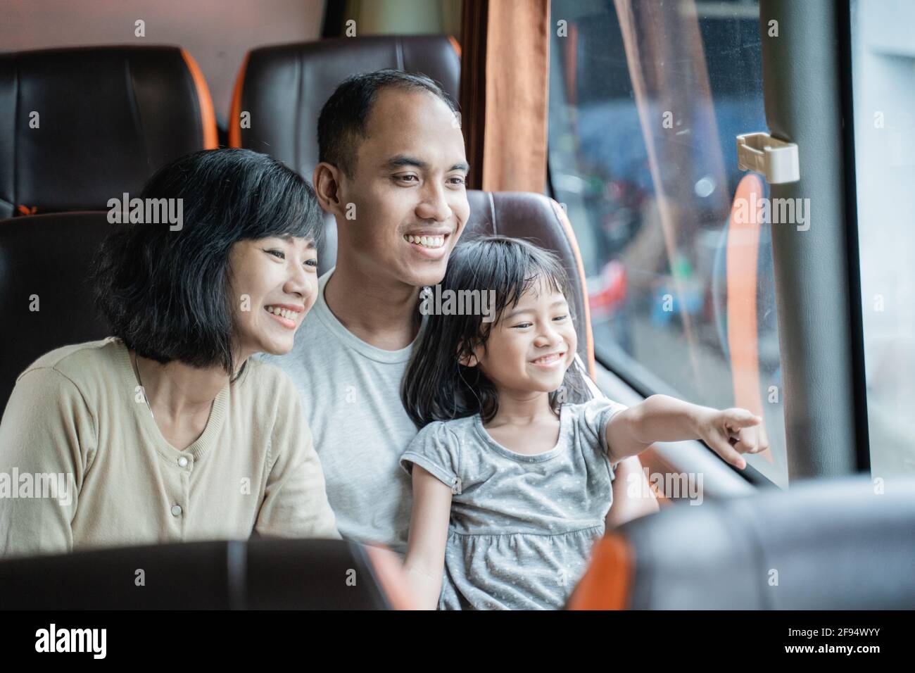 the happiness of a little girl with finger pointing when her parents ...