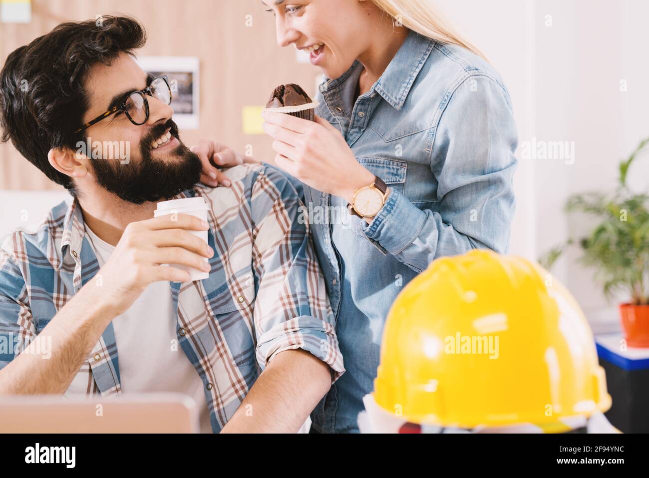 Happy cheerful couple of engineer coworkers having a break with a ...
