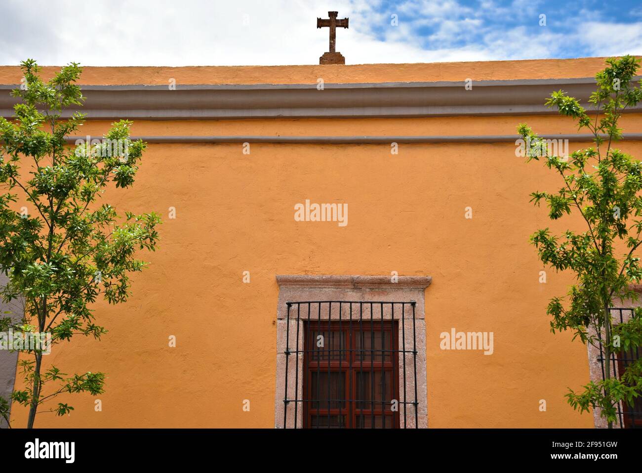 Old Colonial house facade with a Venetian ochre stucco wall and a stone ...