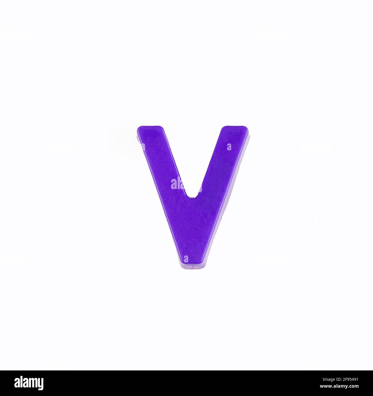 Letter V in violet color - Plastic piece Stock Photo - Alamy