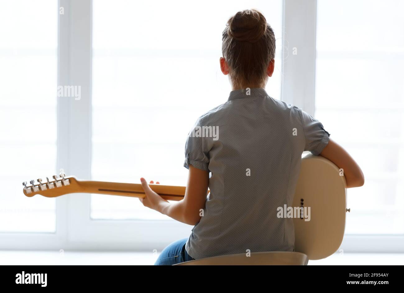 Silhouette of a beautiful girl with a guitar near the window Stock ...