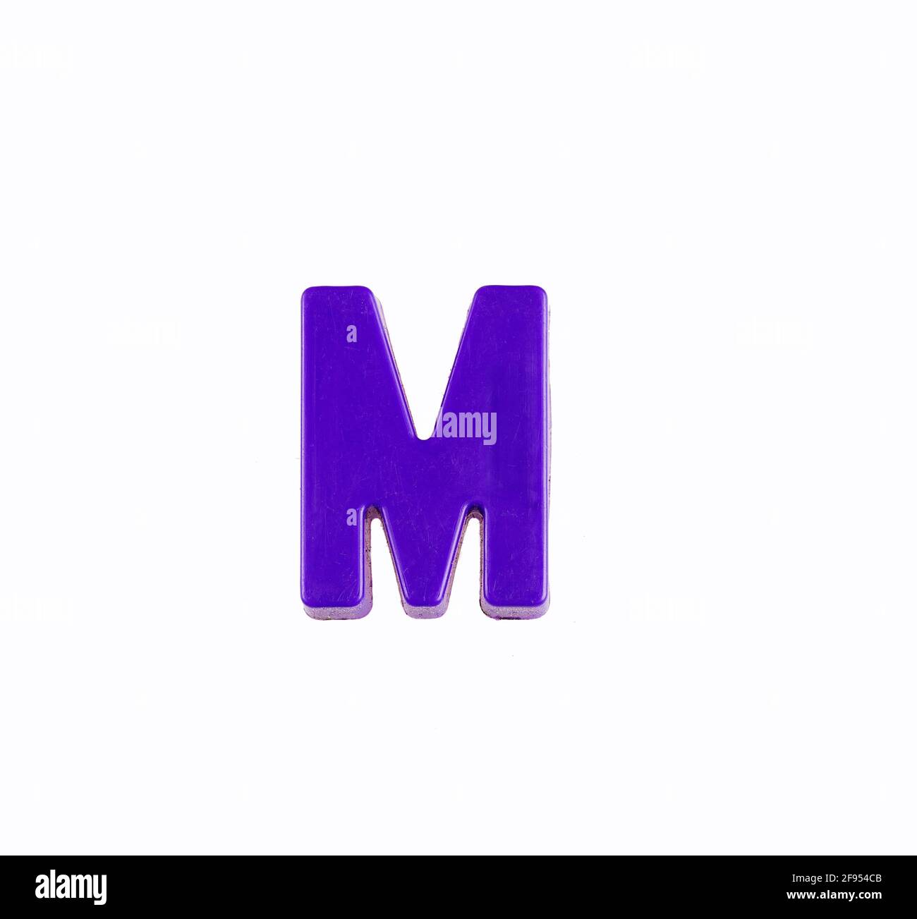 Letter M in violet color - Plastic piece Stock Photo - Alamy