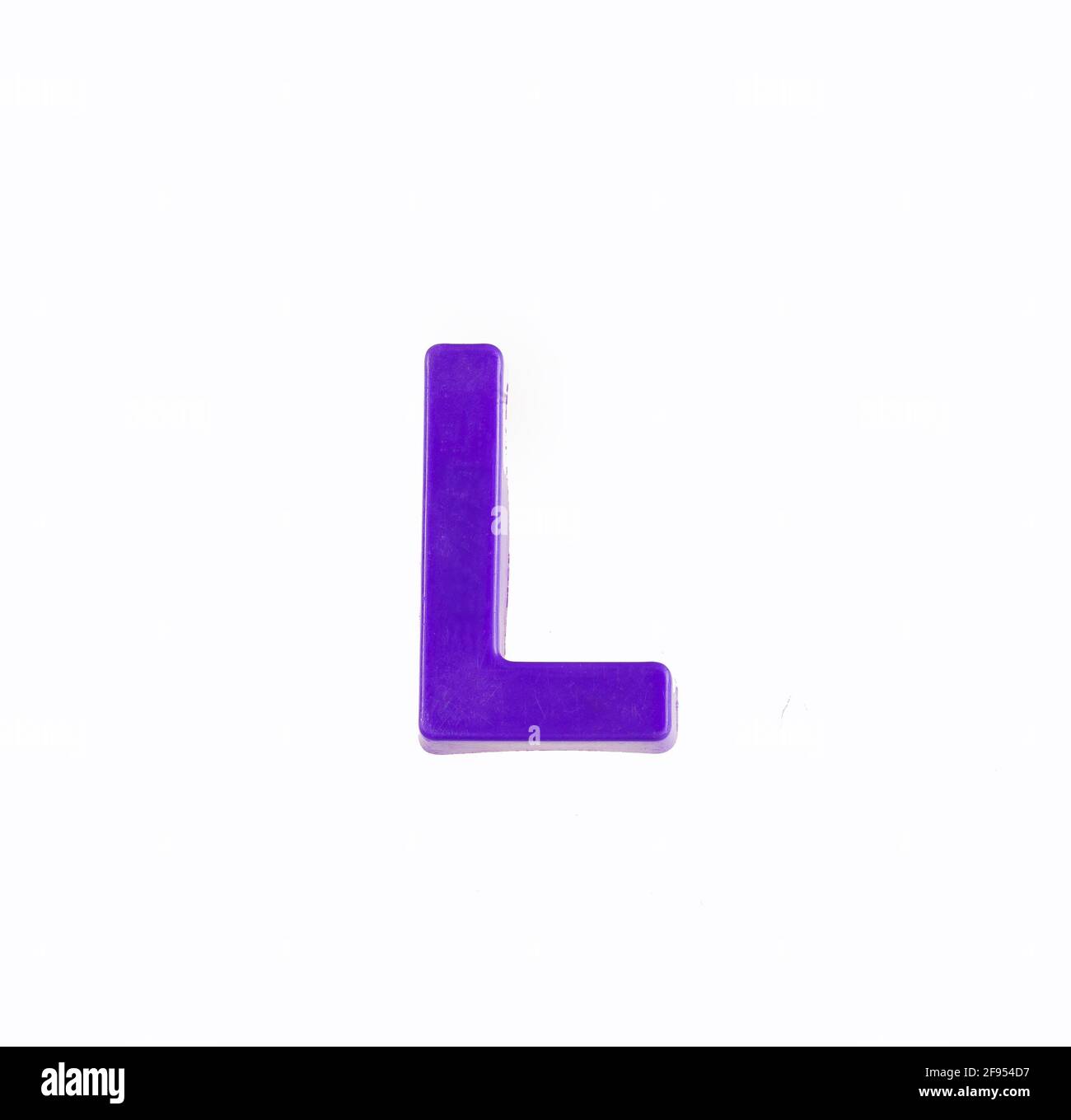 Letter L in violet color - Plastic piece Stock Photo - Alamy