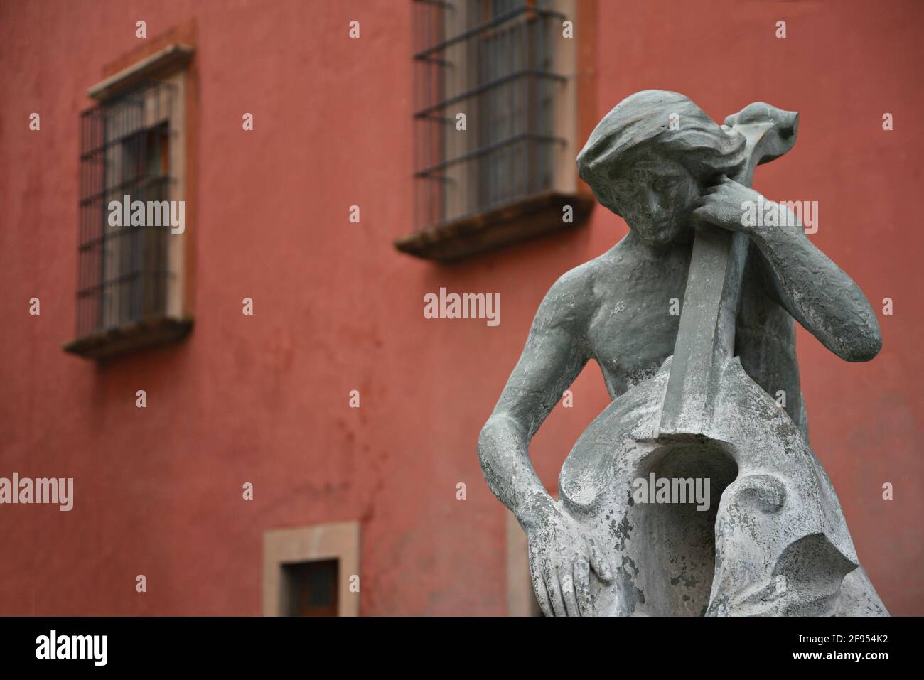 Cello artist stone statue in the historic center of Santiago de ...