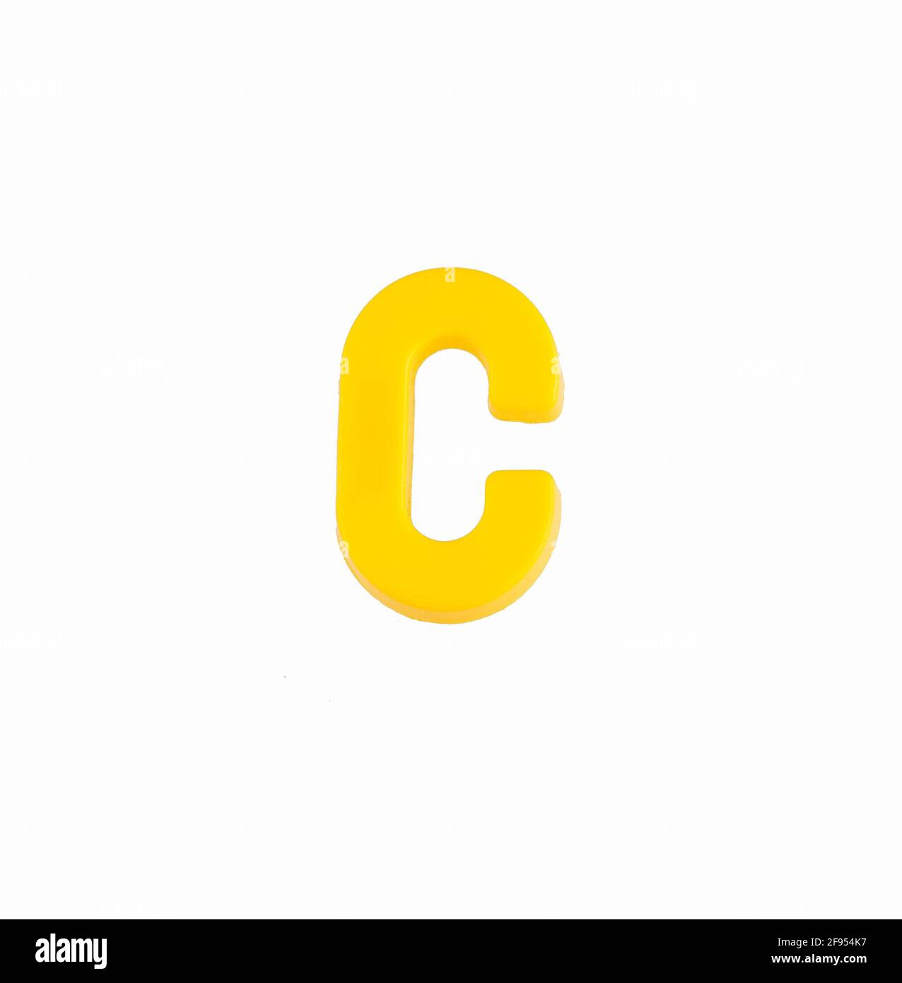 Letter C in yellow color - Plastic part Stock Photo - Alamy