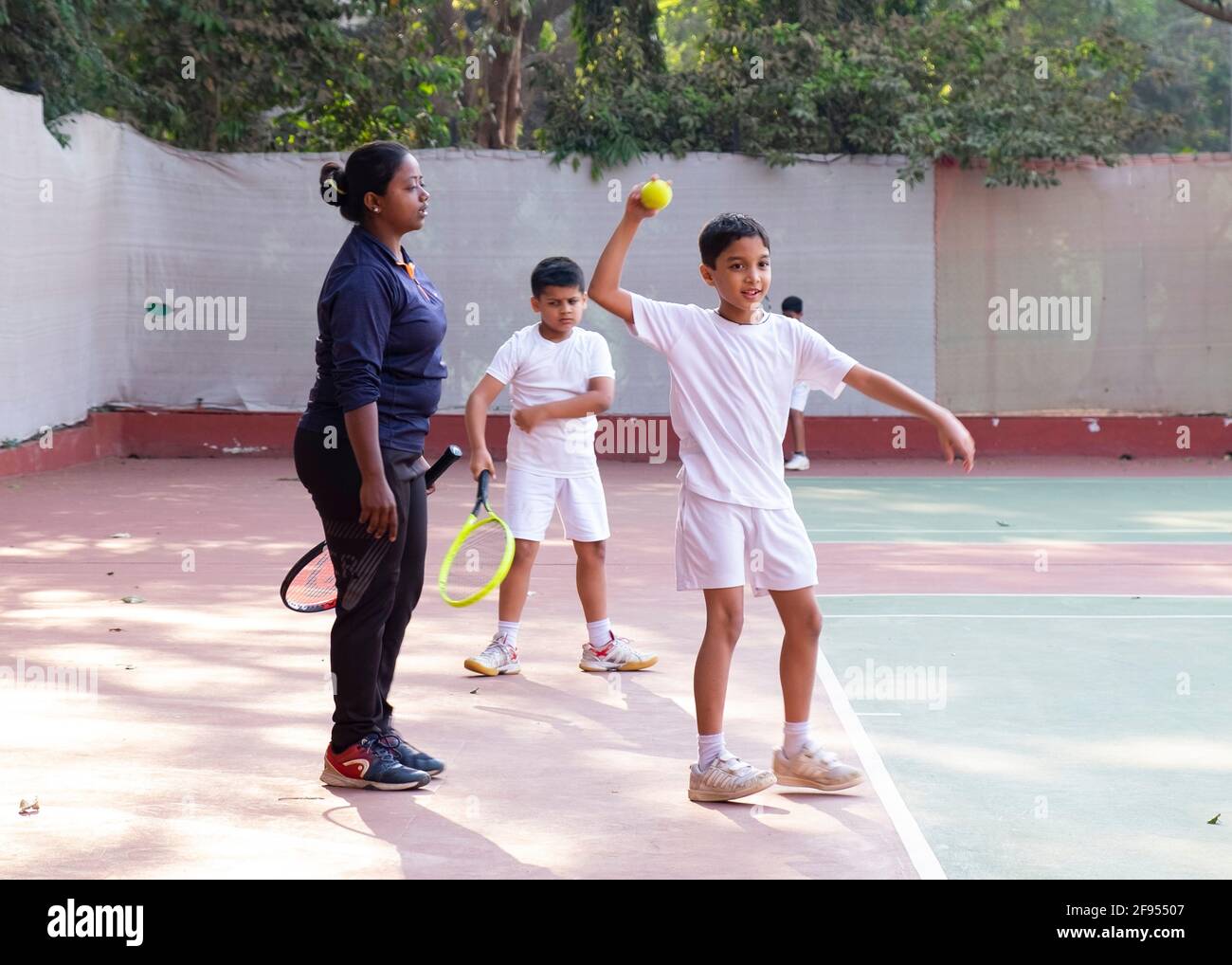 Young children having tennis lessons with a coach at the SPG (Shivaji ...