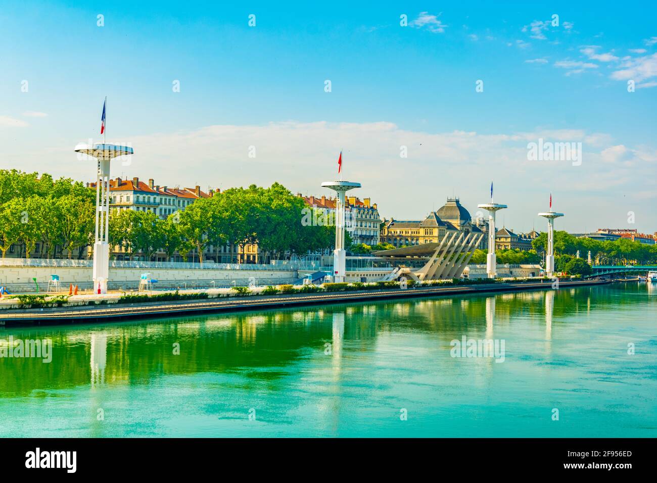 Giant flagpoles over a public swimming pool on riverside of Rhone river ...