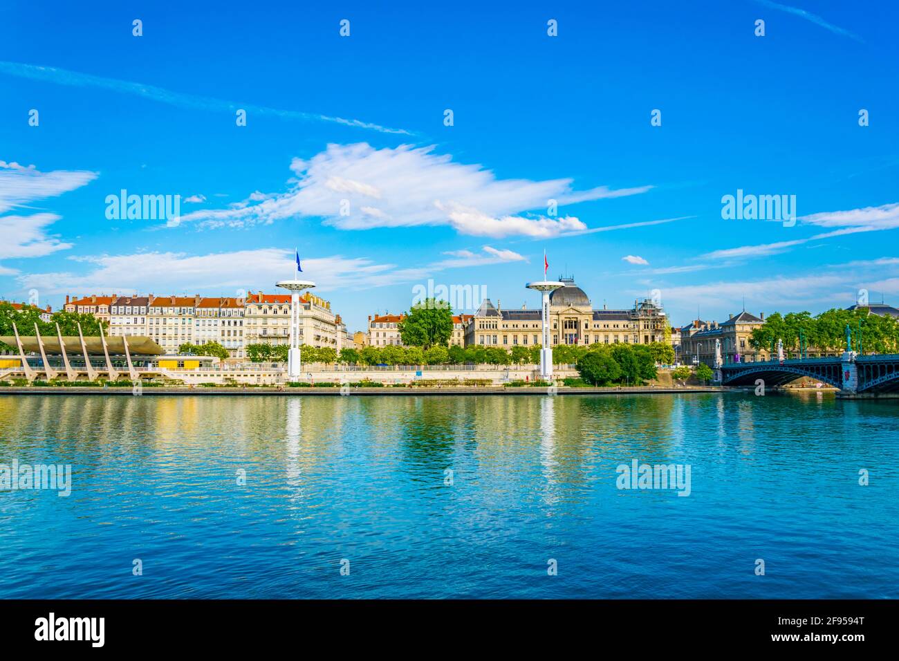 Giant flagpoles over a public swimming pool on riverside of Rhone river ...