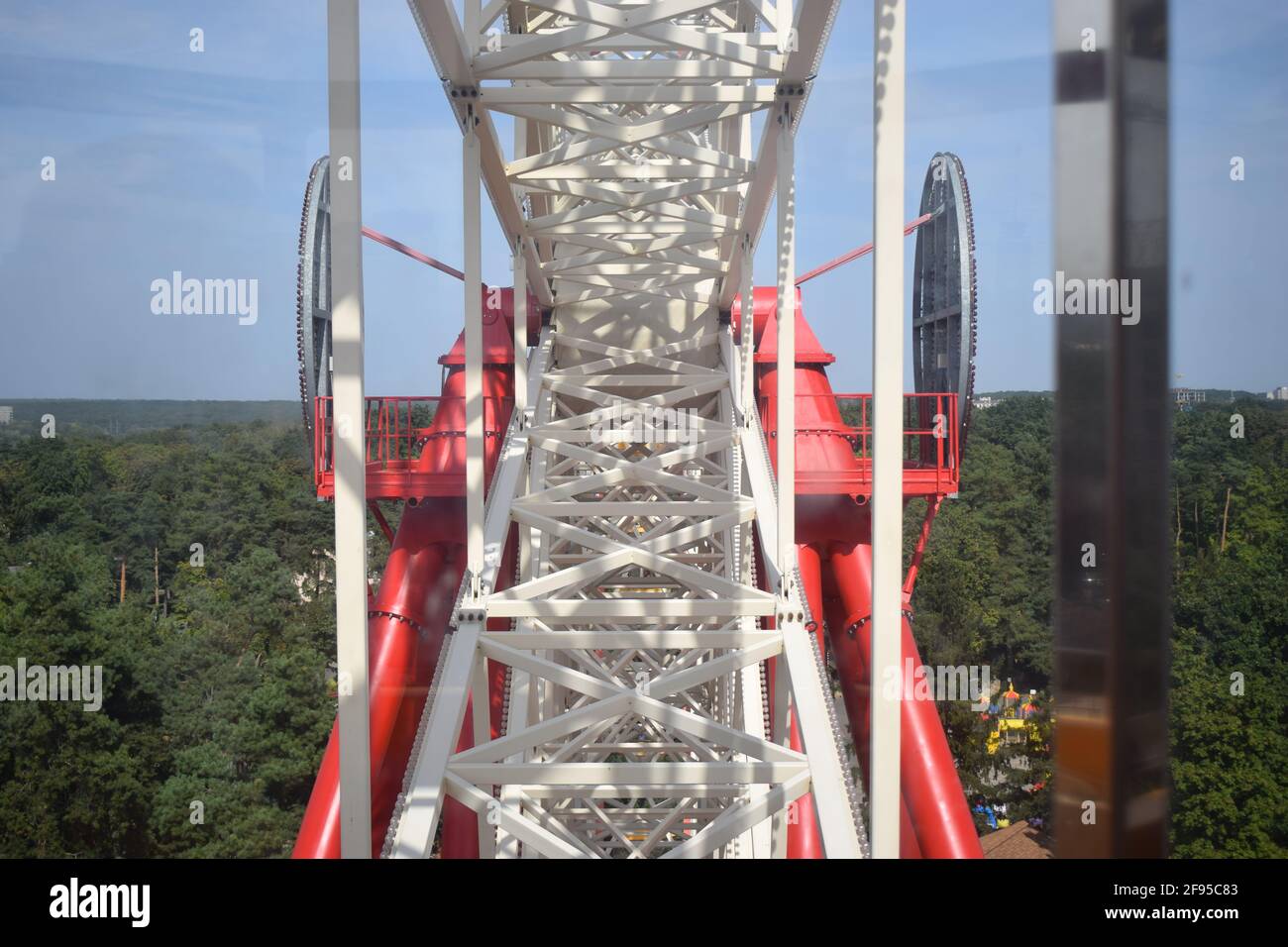 Ferris wheel construction seen from one of the cabins. Part of a white ...