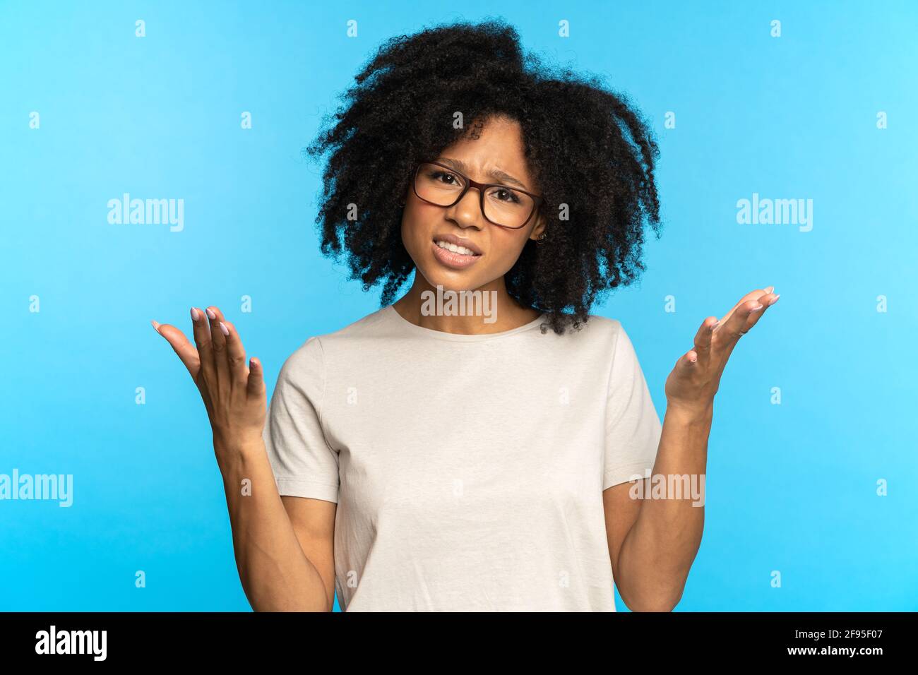 Portrait of mixed race shocked female with frowning open mouth, angry ...