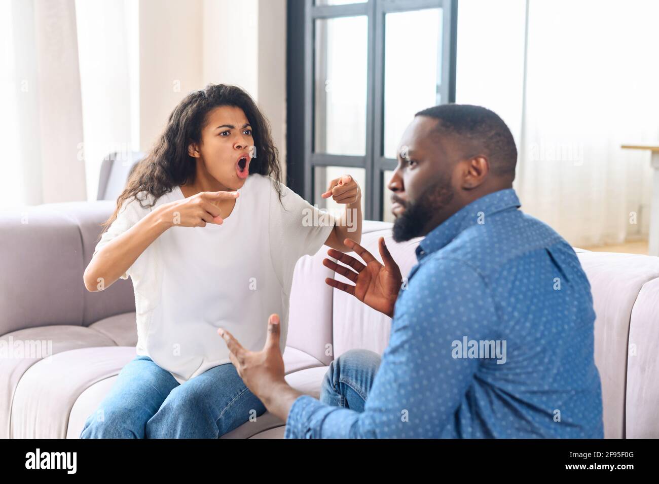 Stressed young married family couple arguing emotionally, blaming ...