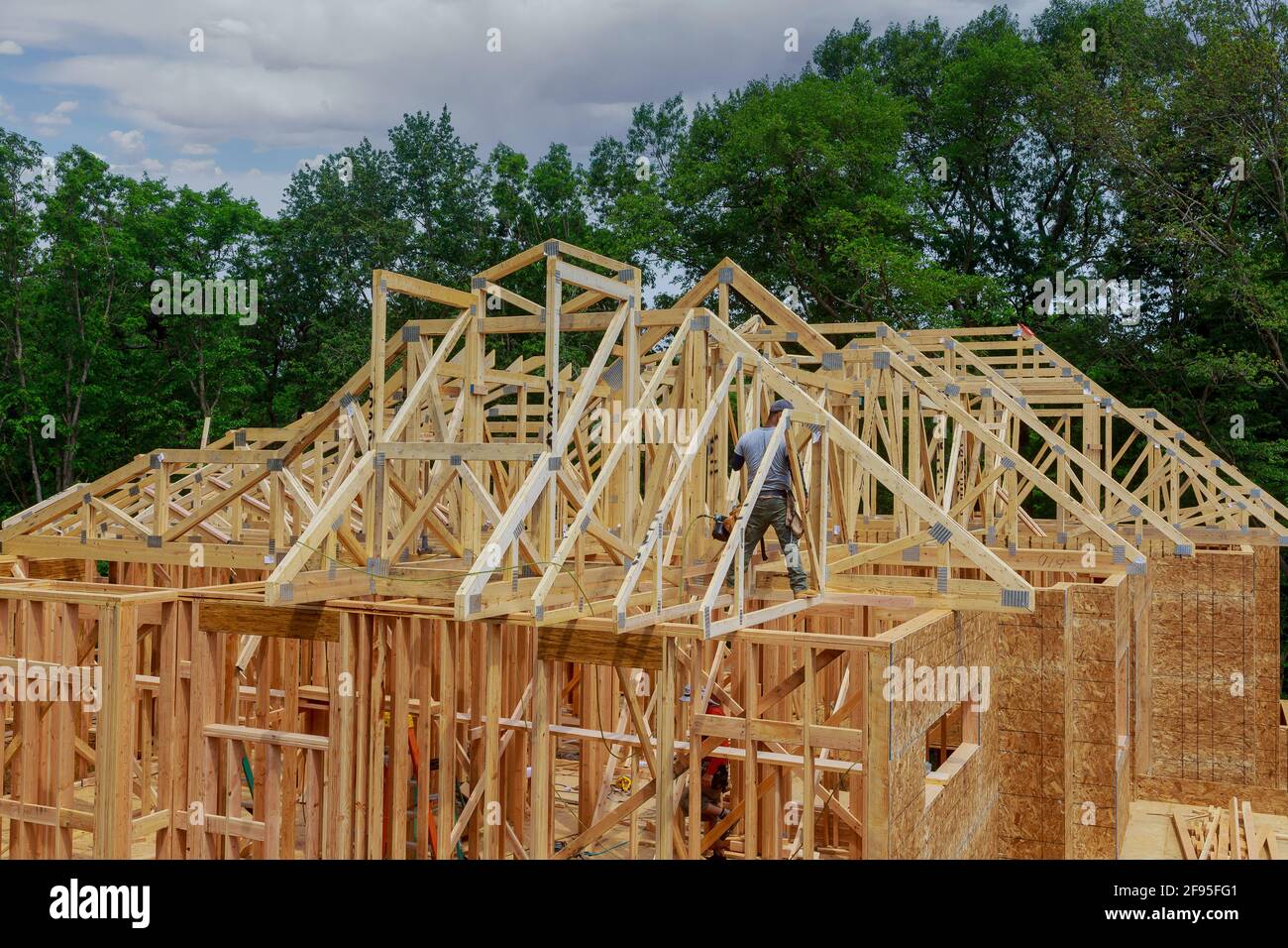 Unfinished of view of a house residential construction framing against ...