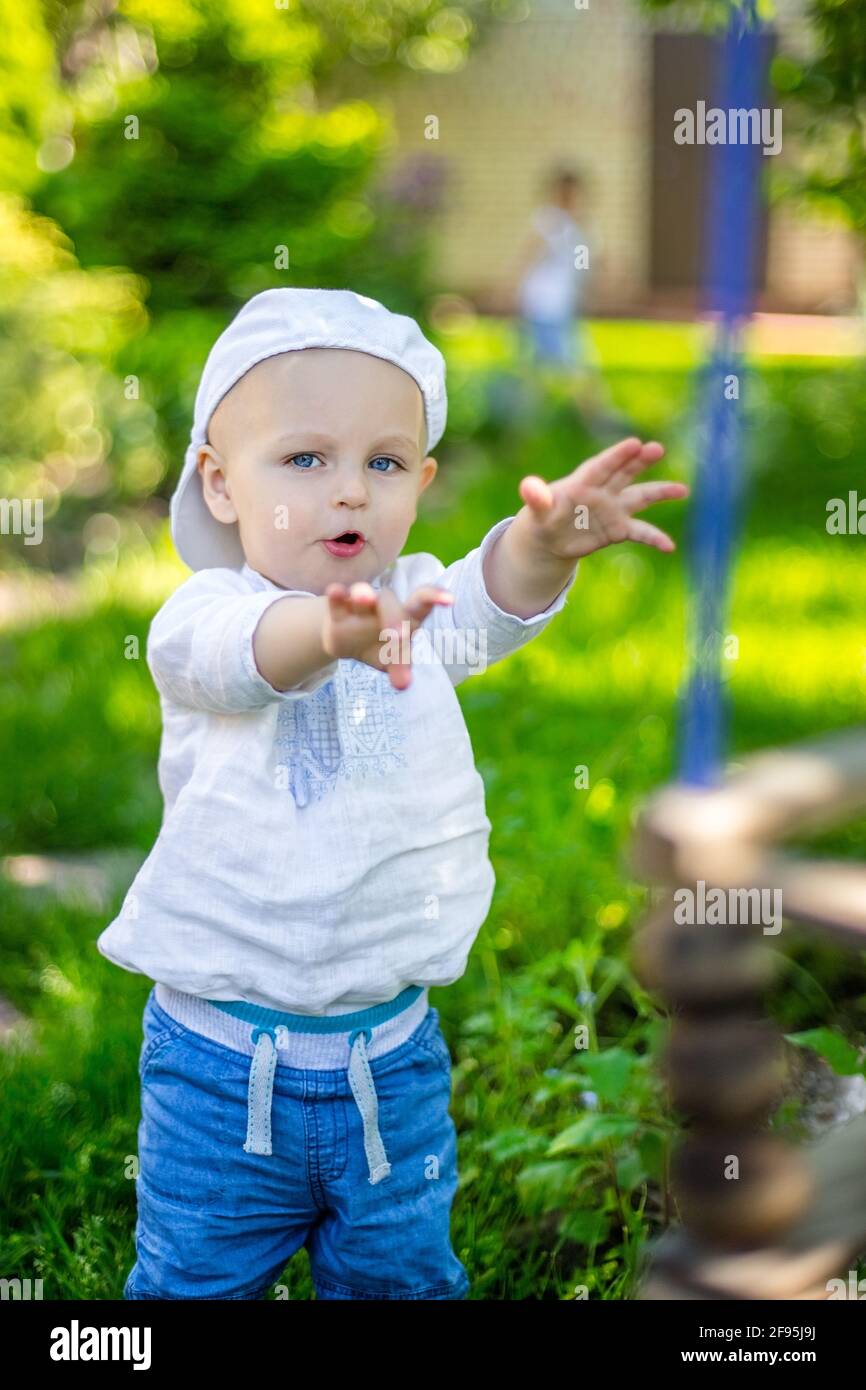 Cute little boy in the spring garden Stock Photo - Alamy