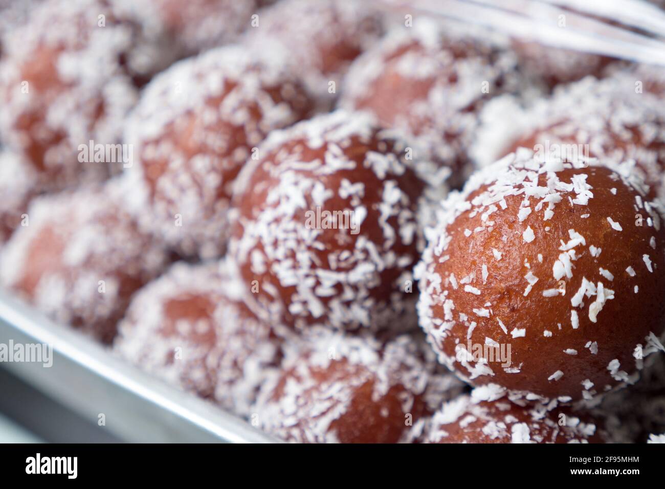 Closeup shot of small ball pastries with coconut flakes Stock Photo - Alamy