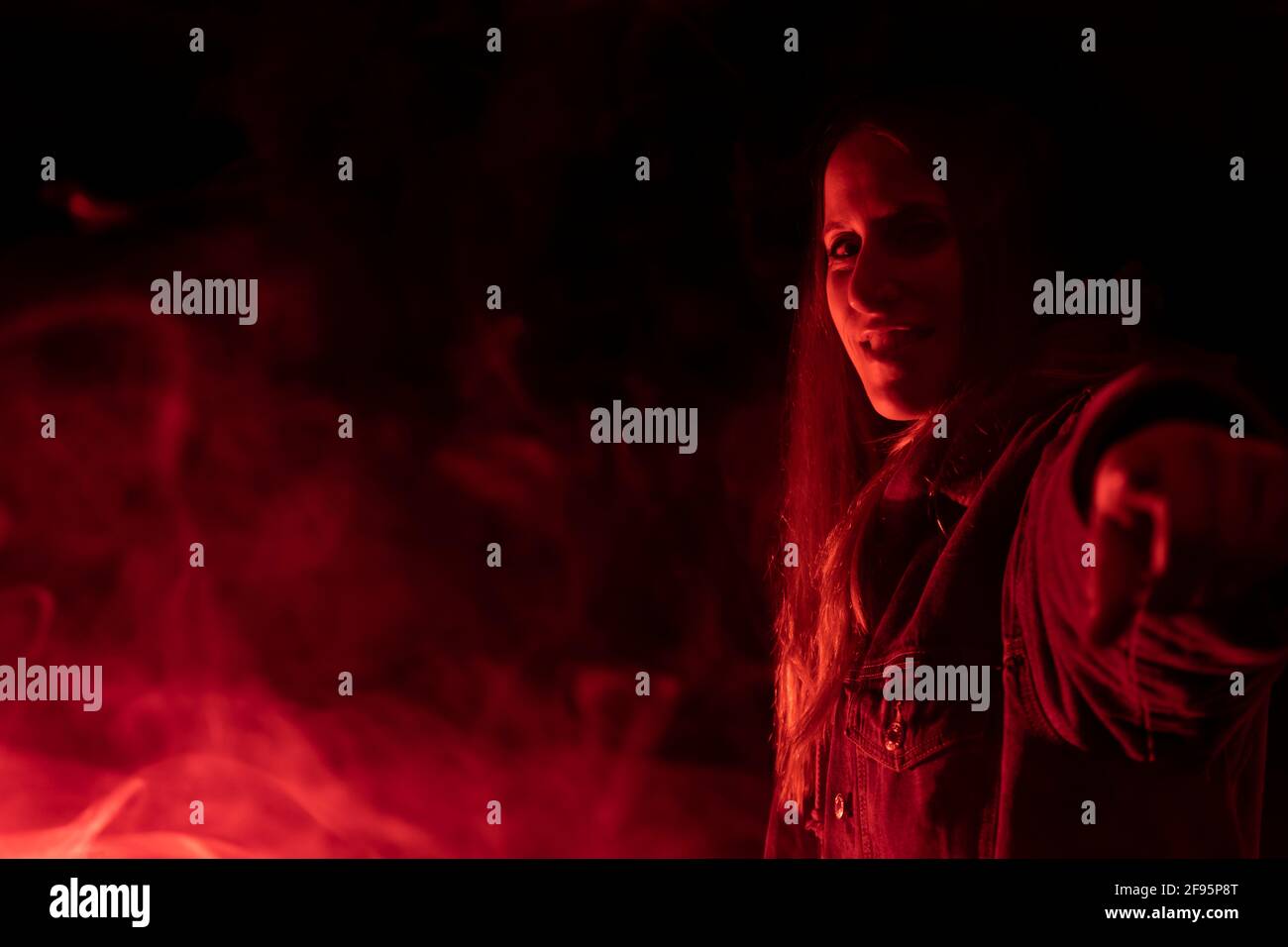 Smoke and vaping concept.Beautiful woman vaper smoking pointing at the ...