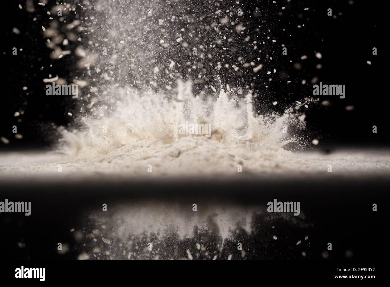 The loose flour lies on the black background Stock Photo - Alamy