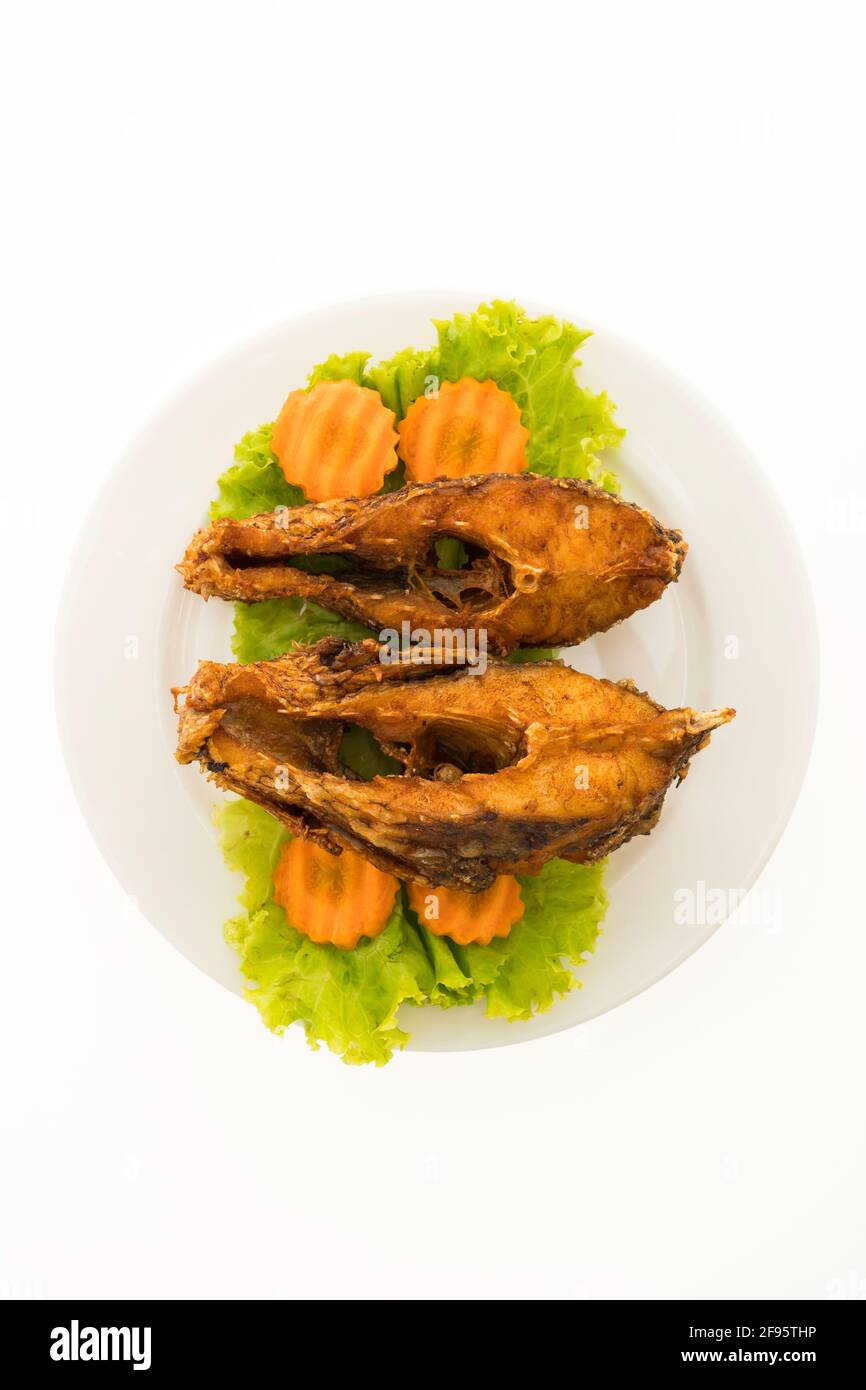 Fried fish in white plate isolated on white background Stock Photo - Alamy