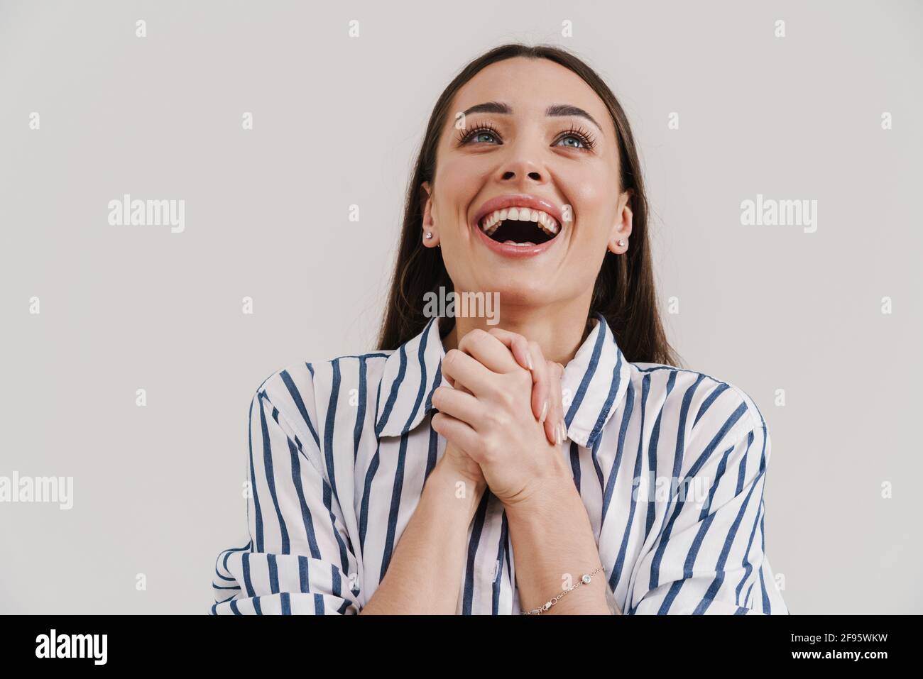 Delighted beautiful brunette girl exclaiming and looking upward ...