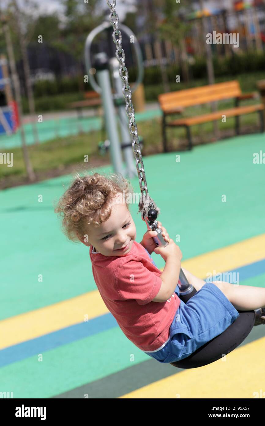 Kid is playing at cableway at playground Stock Photo - Alamy