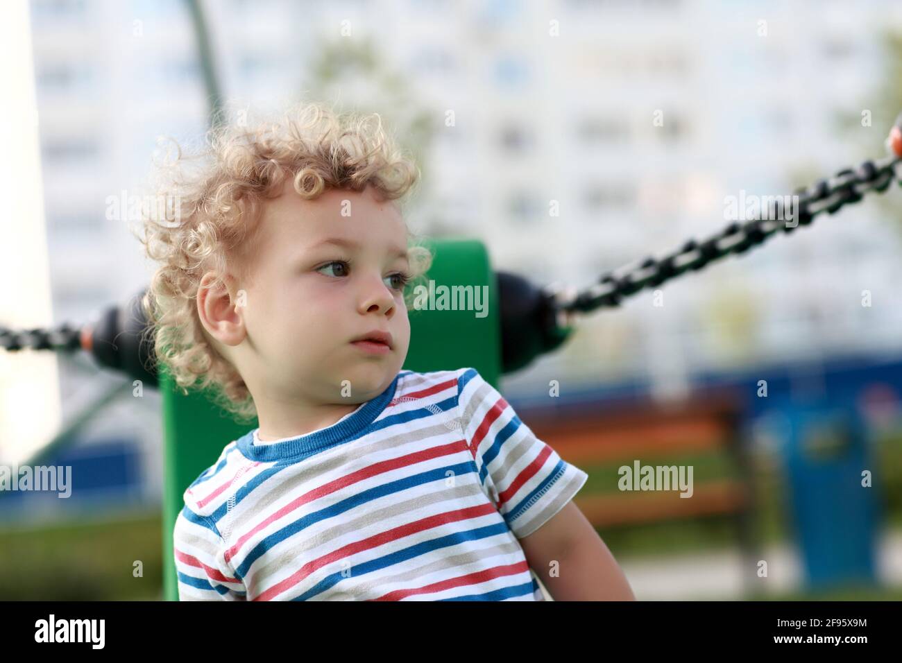 Thinking child at outdoor playground in summer Stock Photo - Alamy
