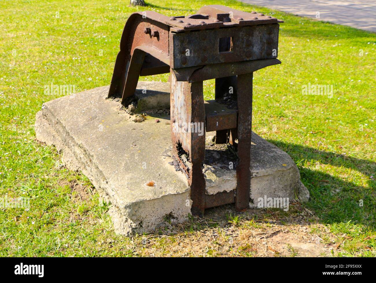 Old rusting iron bump stop set in concrete at the end of a no longer ...