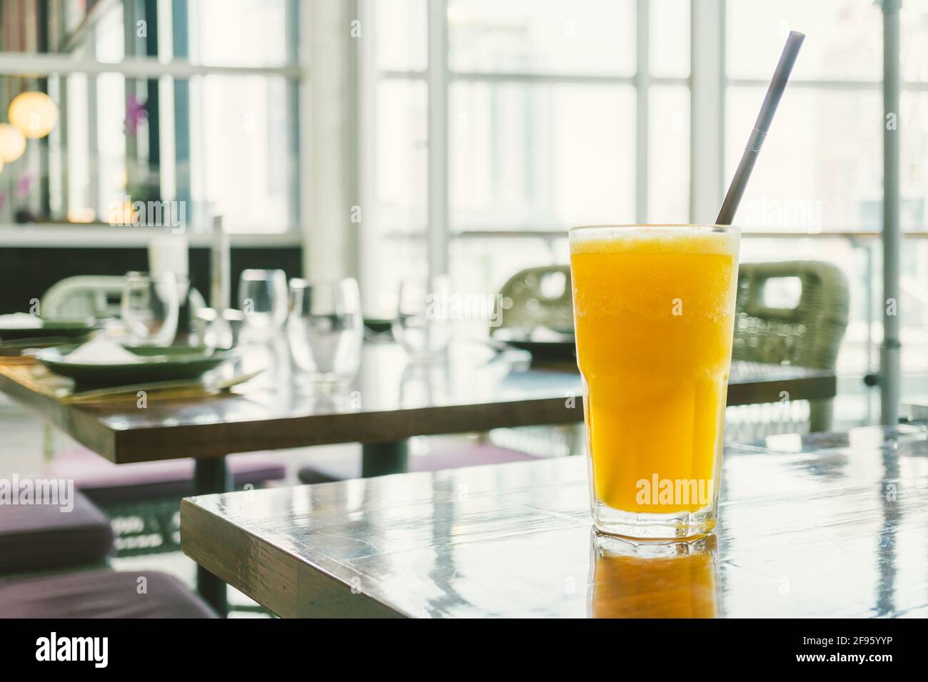 Iced orange juice smoothies glass on table - Color Filter Processing ...