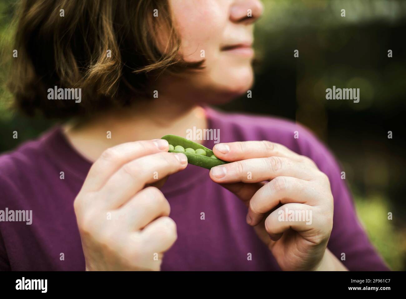 Young woman eating from hi-res stock photography and images - Alamy