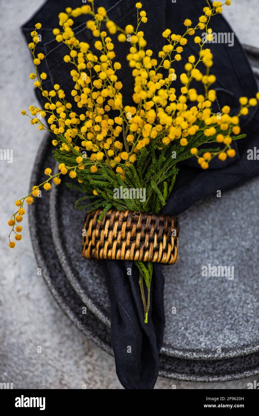 Spring mimosa flowers and table setting Stock Photo - Alamy