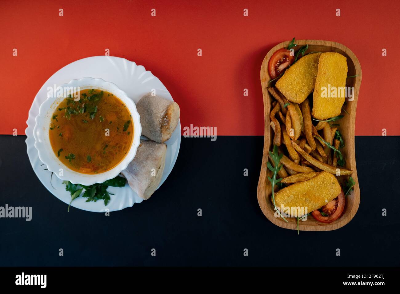 Overhead shot of a hot soup and fried chicken with french fries over ...