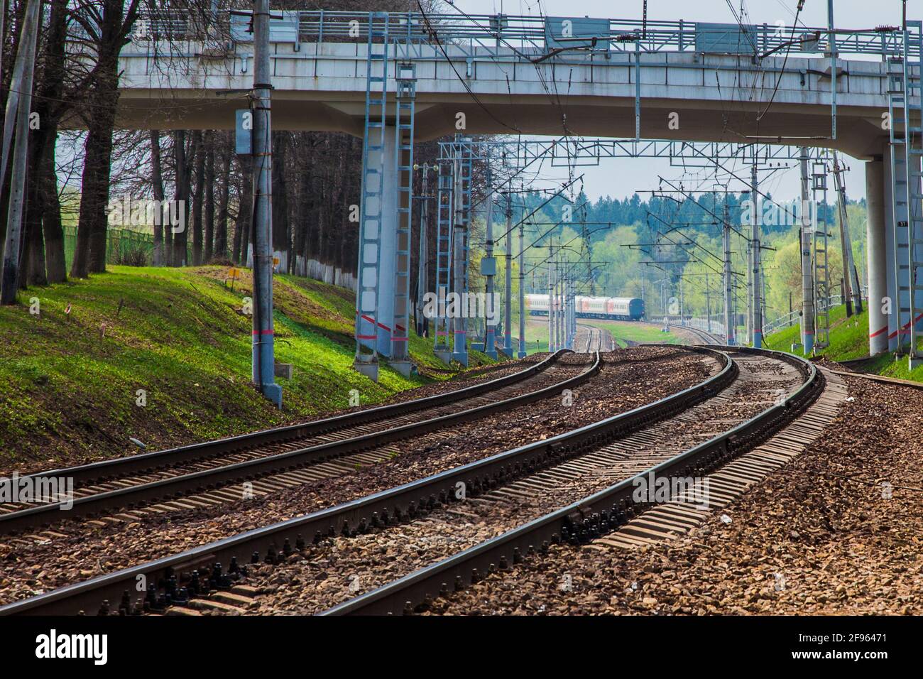 Railroad tracks and passenger train receding into the distance Stock ...