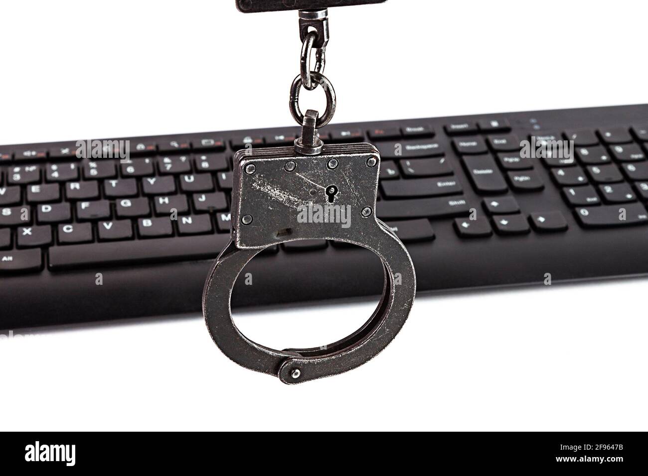 Police handcuffs and computer keyboard on white background Stock Photo ...