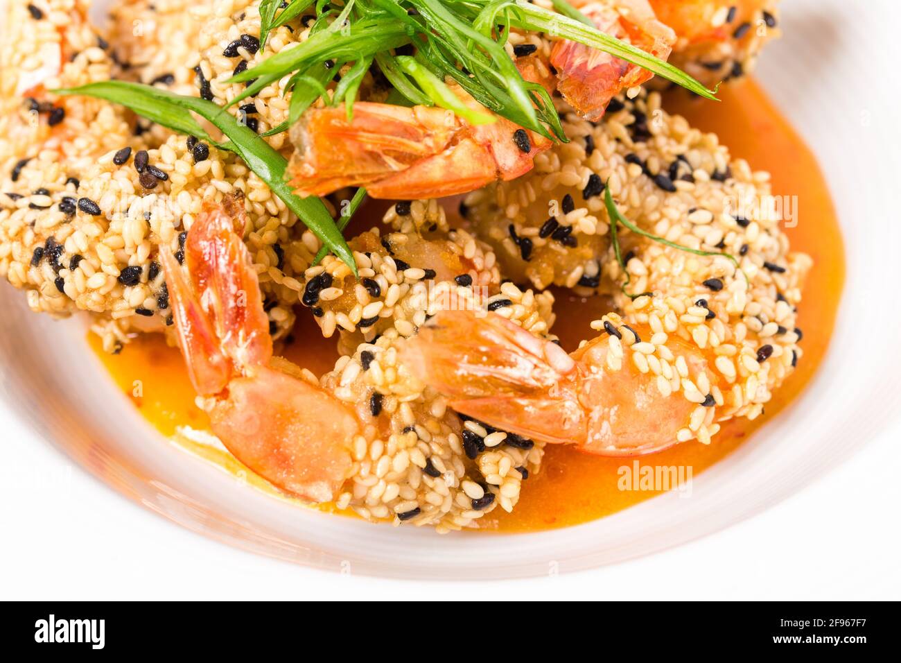 Delicious grilled jumbo shrimps with sesame and sliced scallions on ...