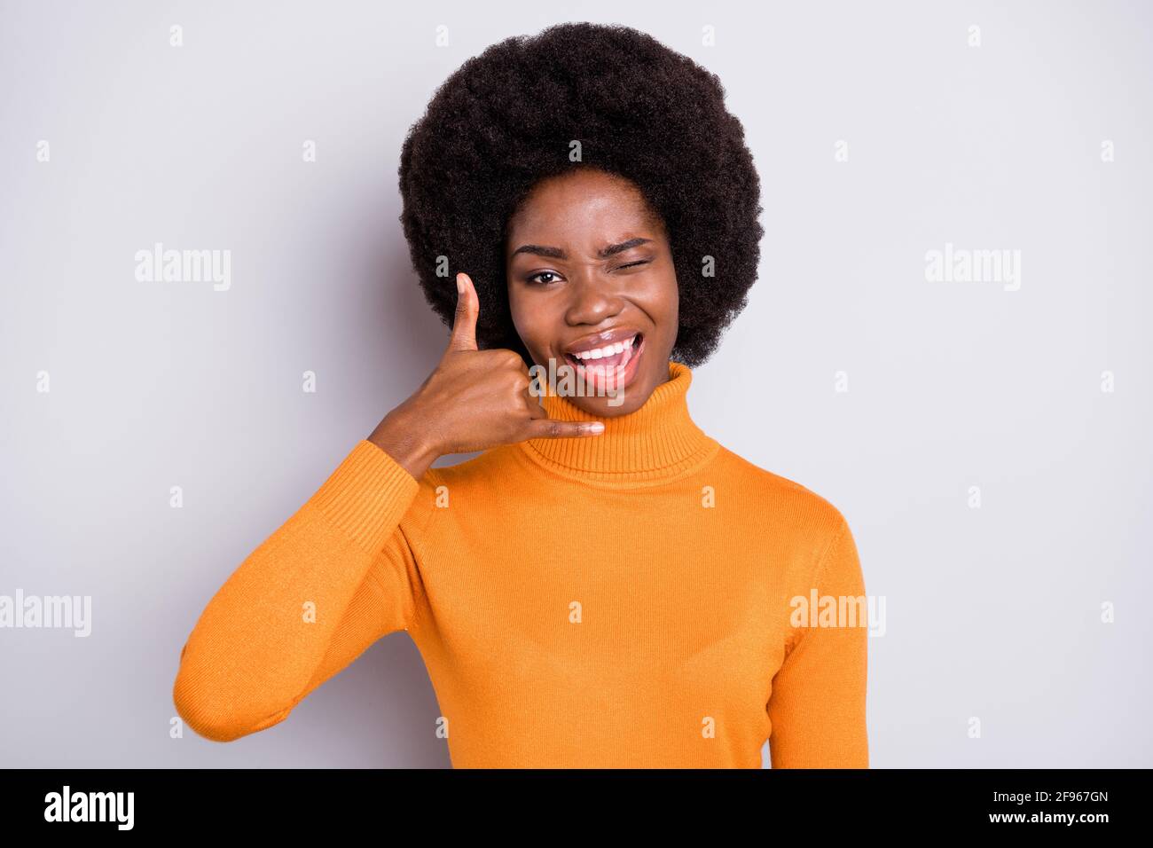 Photo of flirty happy pretty dark skin woman make call me fingers ...