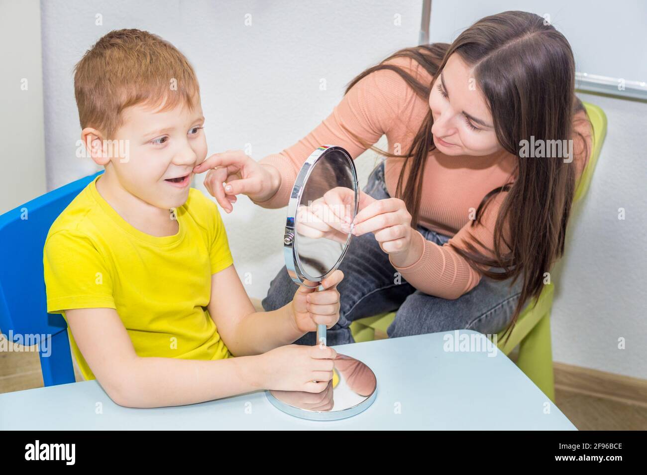 Speech-language pathology concept. Woman and boy Stock Photo - Alamy