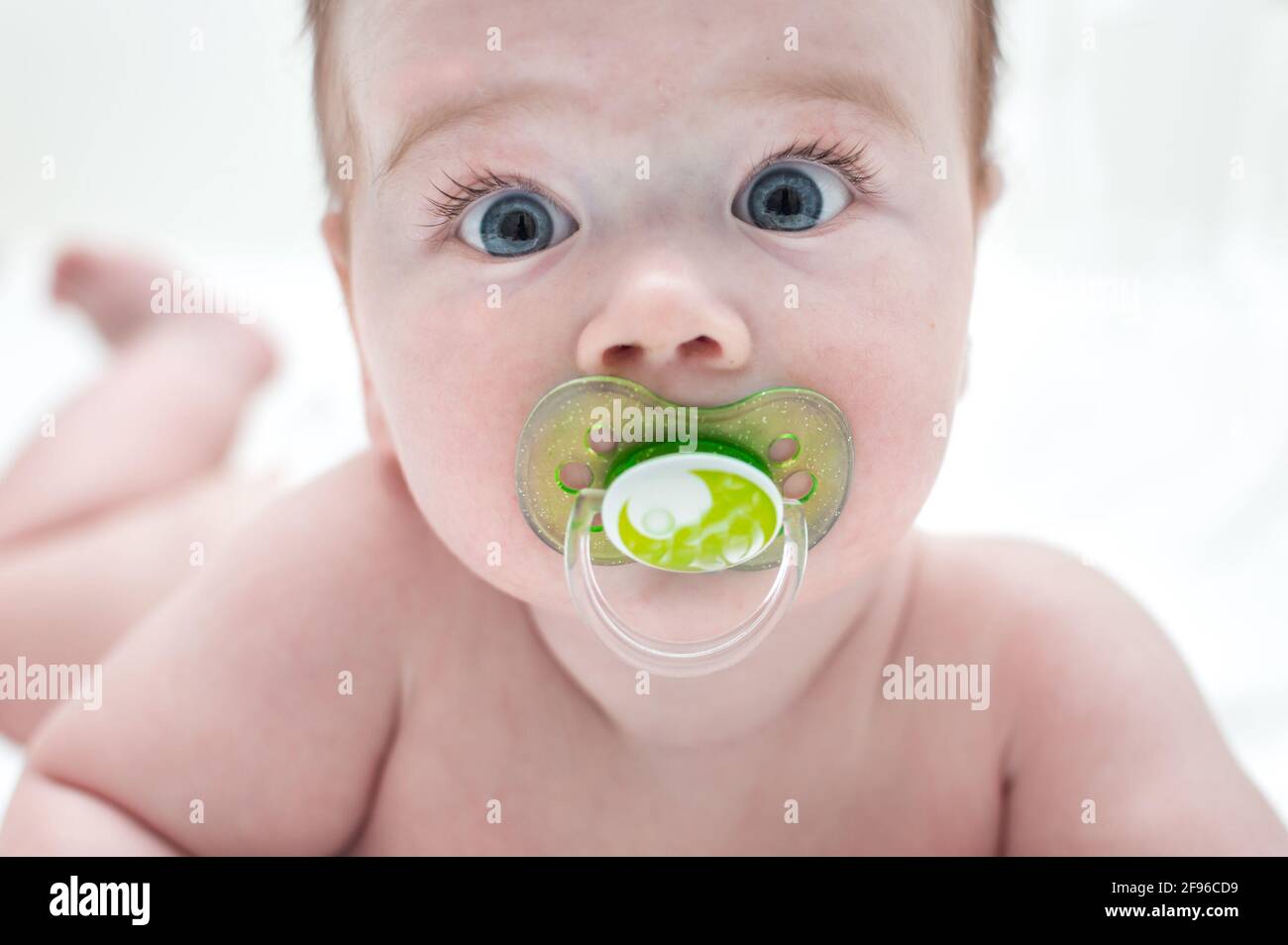 Close-up portrait of baby with pacifier in mouth Stock Photo - Alamy