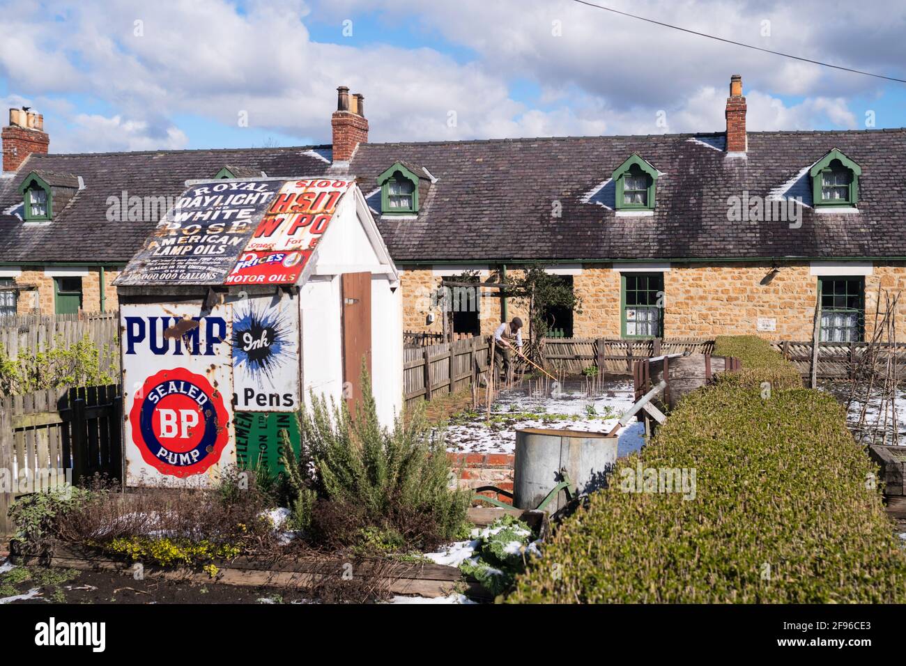 A man works in the garden of a cottage in the 1900s pit village at ...