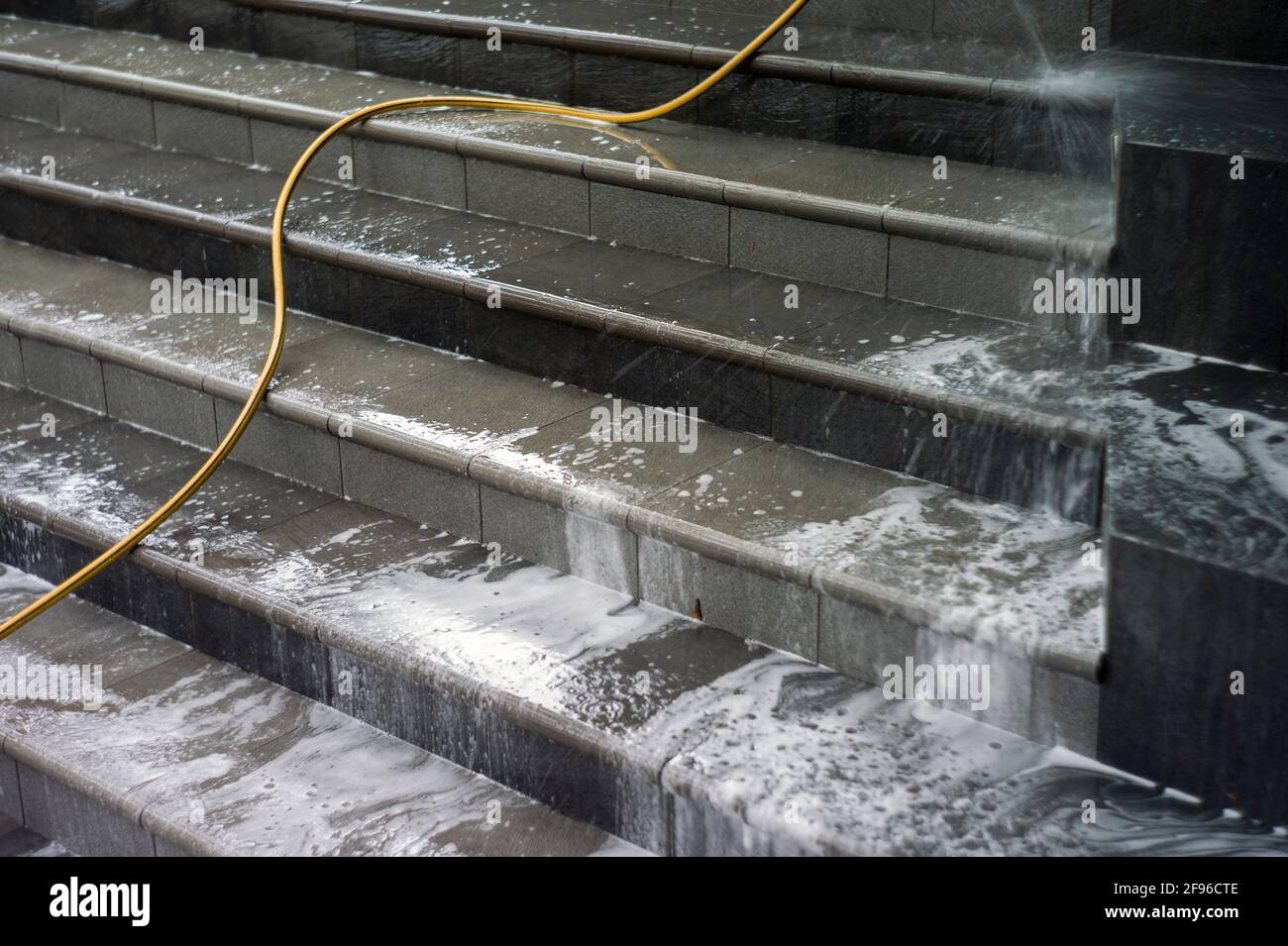 Washing tiled steps with foam and water, outdoor shot Stock Photo - Alamy