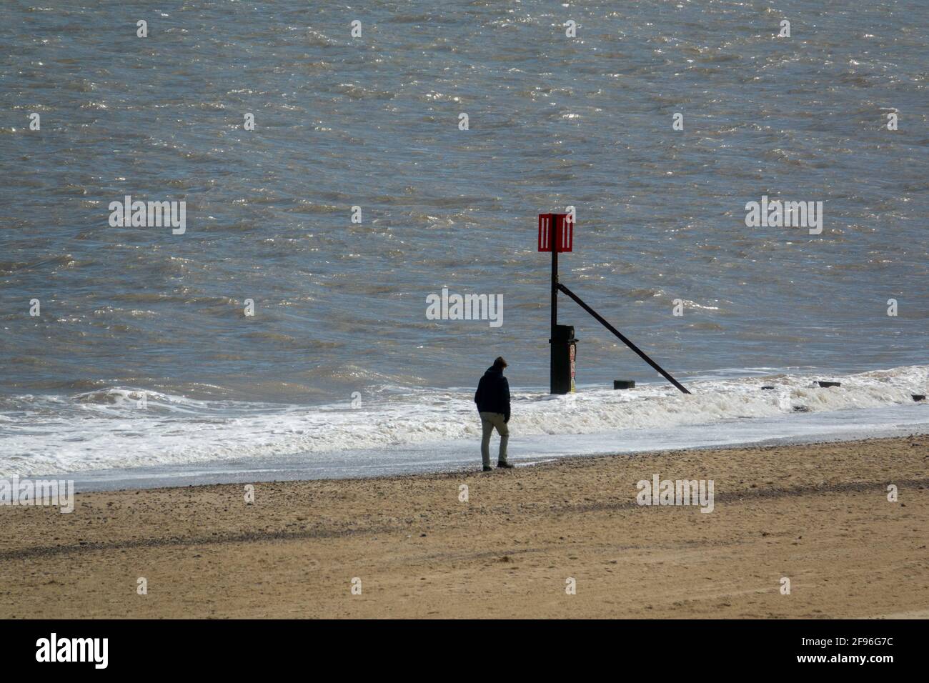 Pakefield Beach, Lone man walking Stock Photo - Alamy
