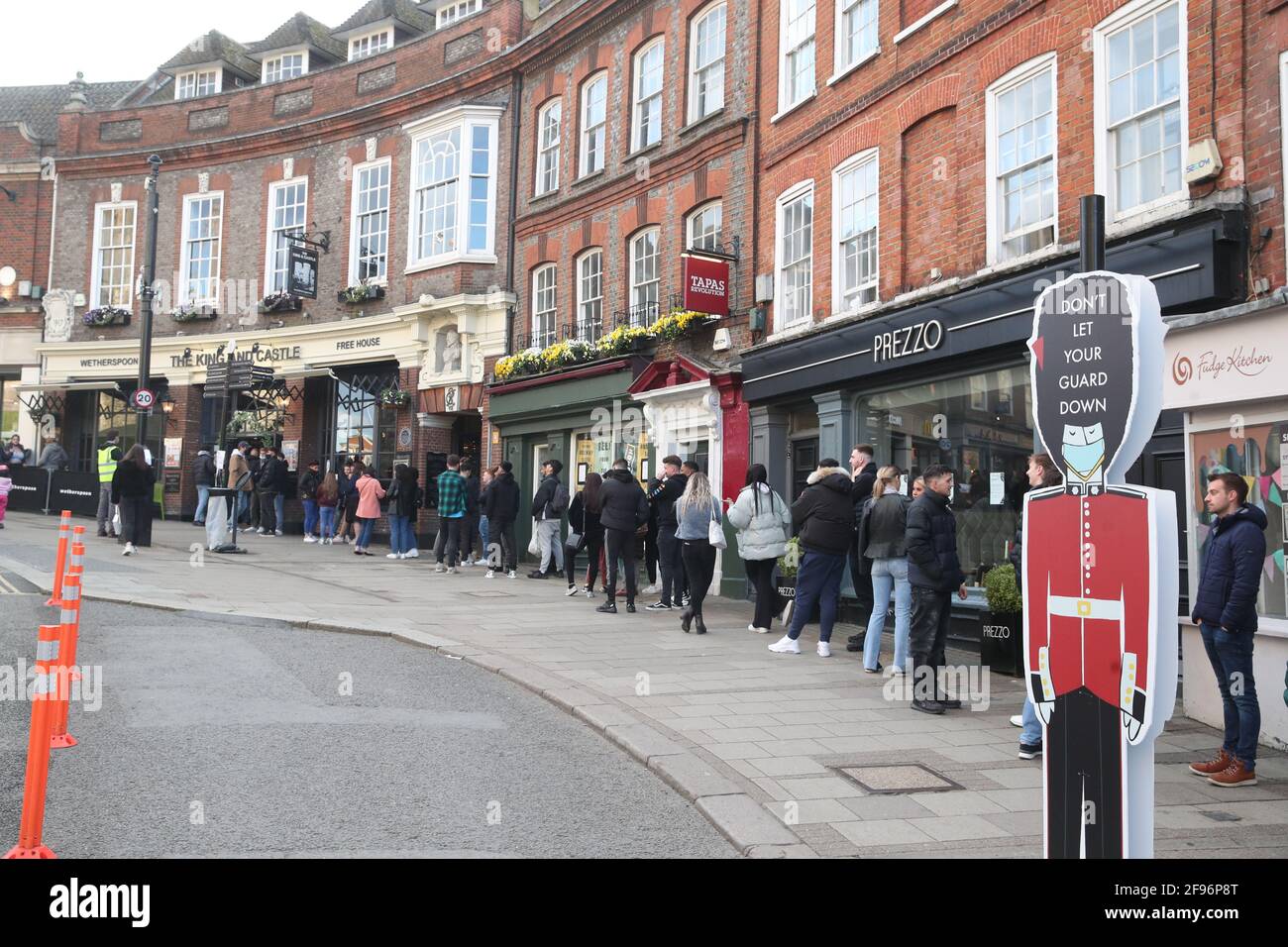 People queue outside Wetherspoon's, King and Castle pub in Windsor ...