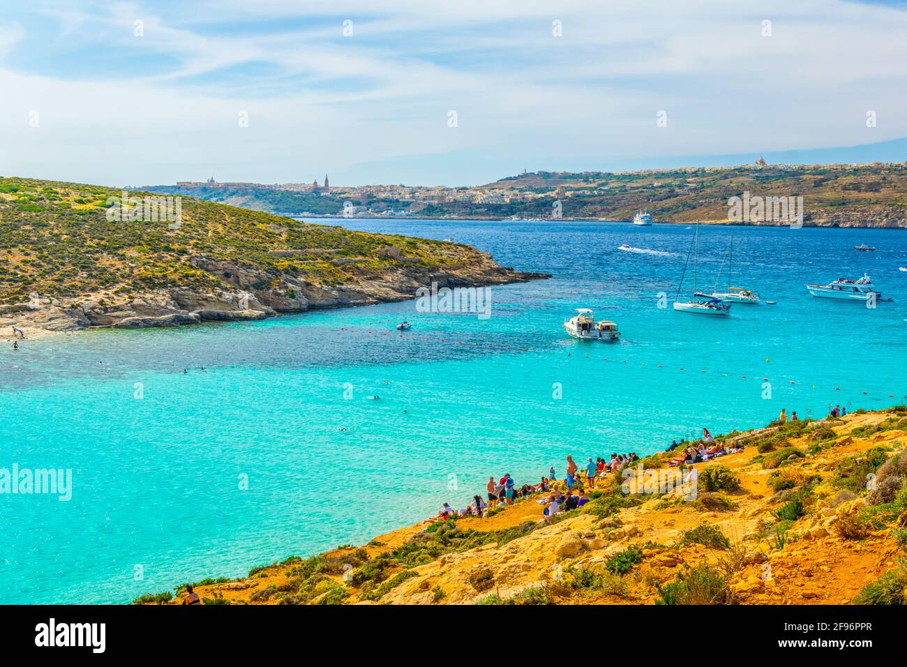Tourists are enjoying turquoise water of the blue lagoon on the comino ...