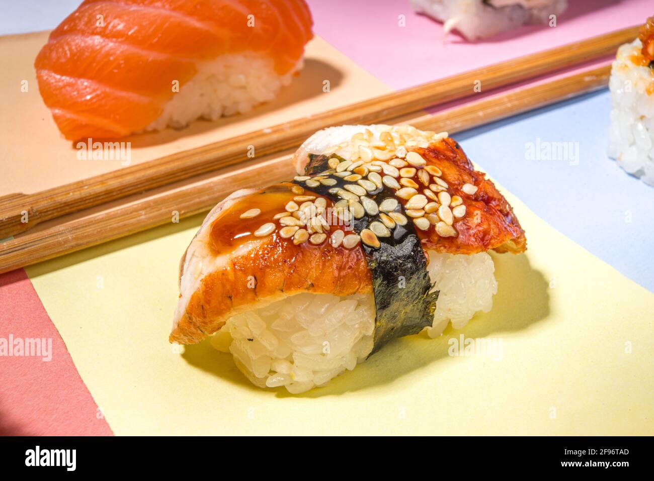 Sushi rolls set with rice and fish and chopsticks on various colorful ...